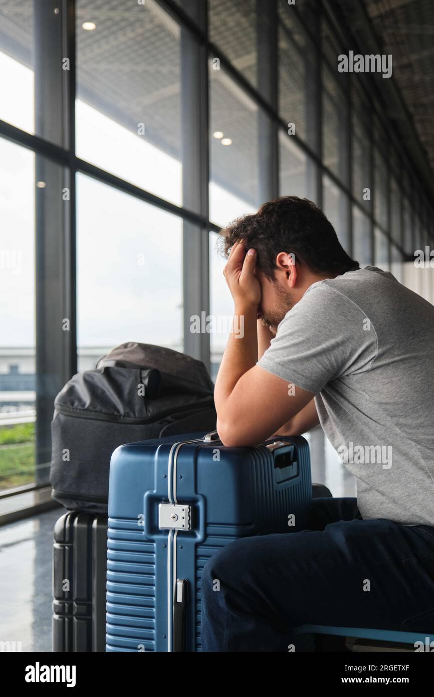 Man crying at the airport, frustrated because his flight was canceled ...