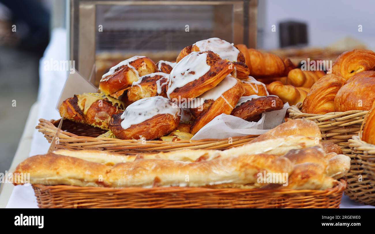 Wicker basket with sweet pastry bread, pistachio swirl and walnut swirl ...