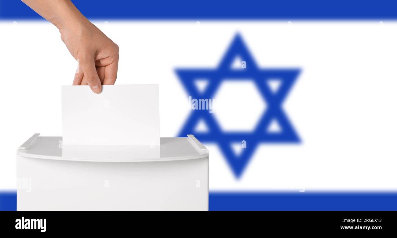 Man putting his vote into ballot box against national flag of Israel ...