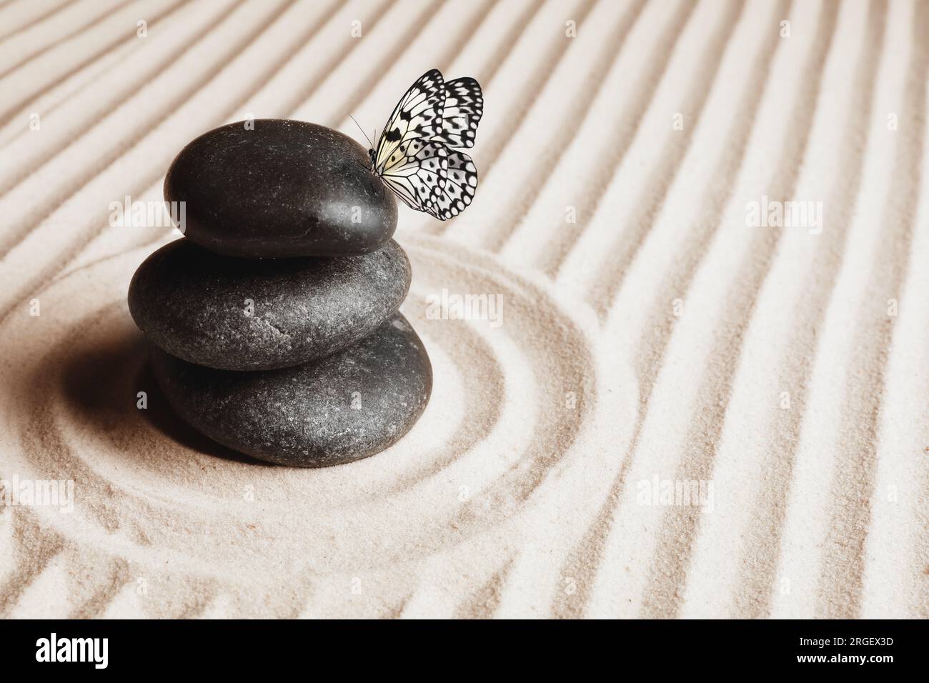 Peace and harmony. Stacked zen garden stones on sand with pattern and ...