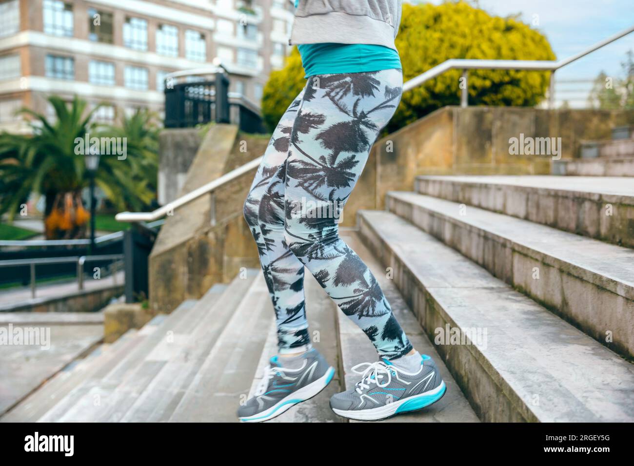 Close up of unrecognizable female runner with palm tree leggings ...