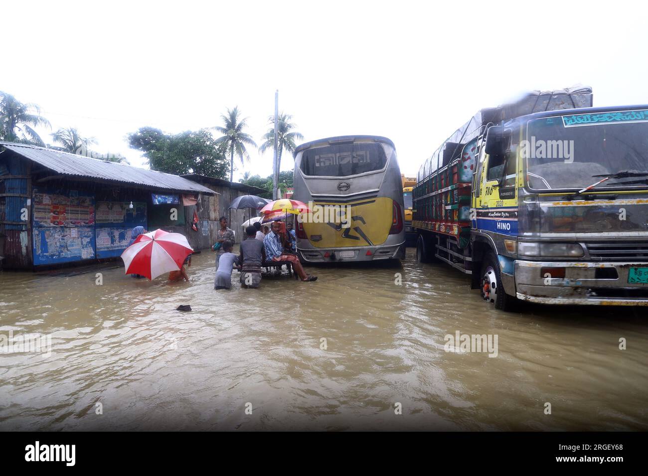 Chattogram. 9th Aug, 2023. Vehicles wade through a flooded street in ...
