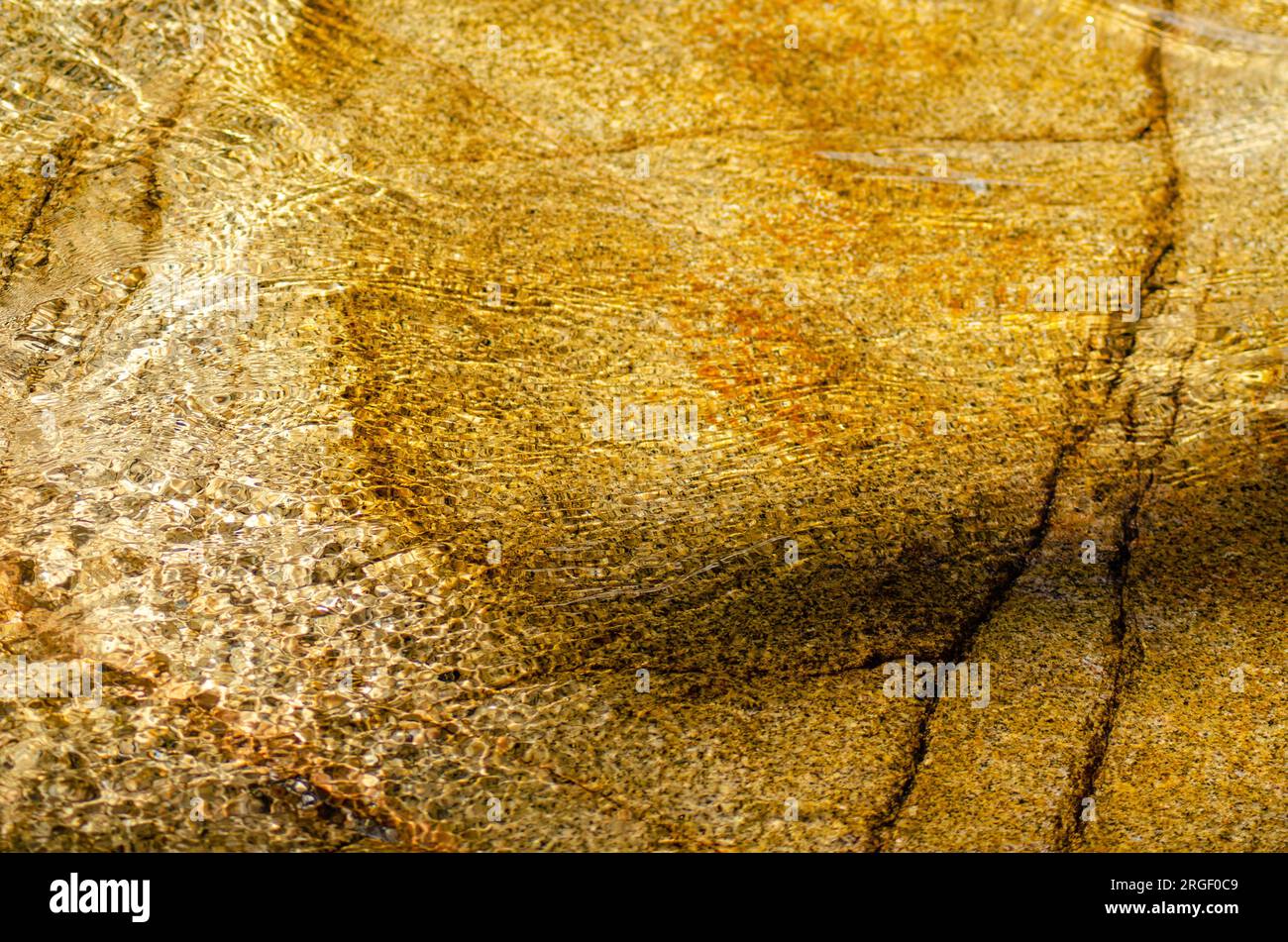 detail of a stream of water on a granite soil Stock Photo - Alamy