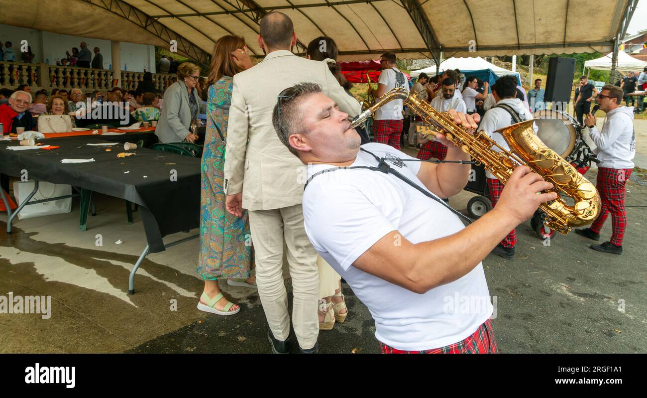 Male musician playing alto saxophone at village fiesta party, Galicia ...