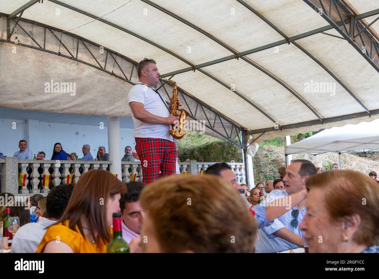 Male musician playing alto saxophone at village fiesta party, Galicia ...