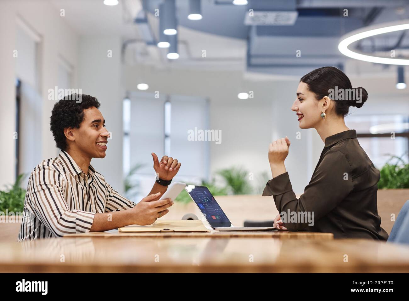 Side view portrait of two Middle Eastern colleagues man and woman ...