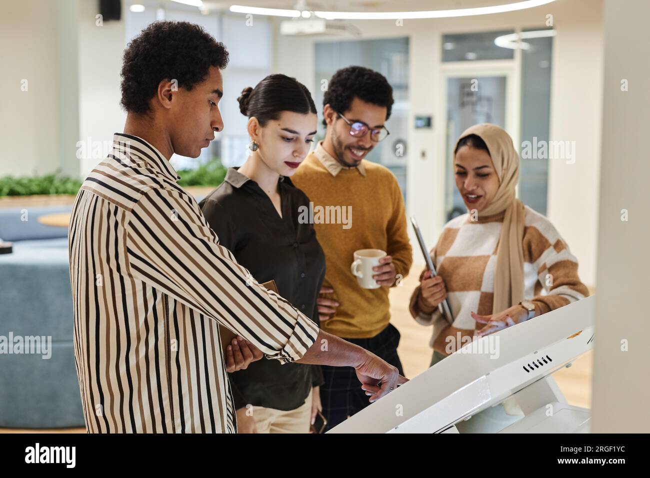 Side view at group of young Arabian business professionals using ...