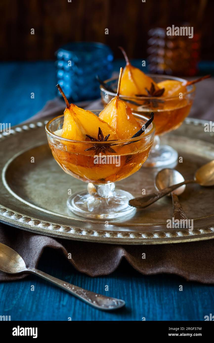 Poached pears in spiced syrup for holiday Stock Photo - Alamy