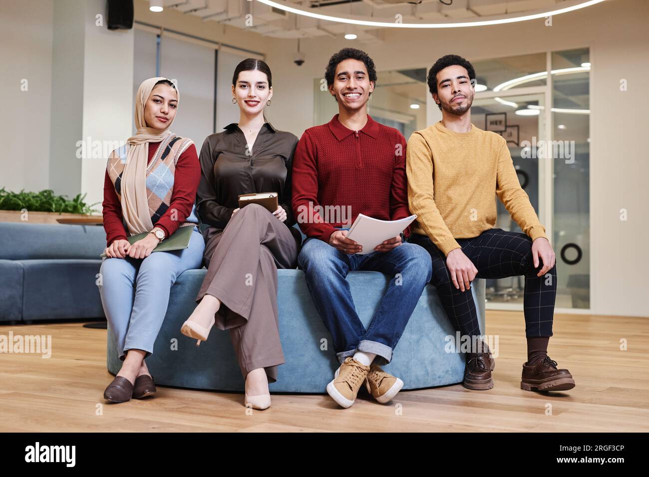 Full length portrait of young Middle Eastern business team posing ...