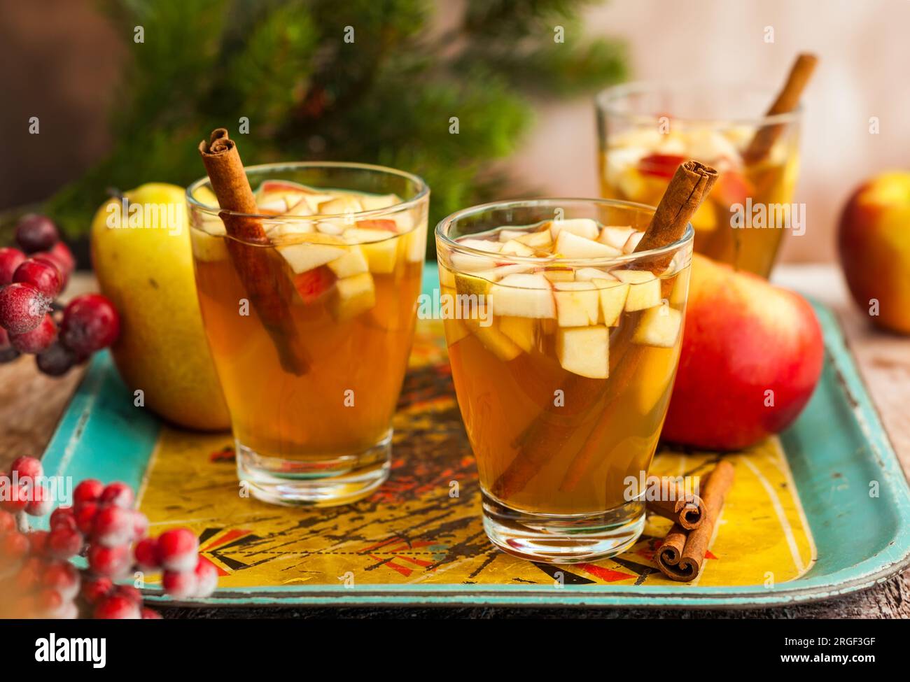 Fall and winter drink with apples,pears and cinnamon in glasses on the ...
