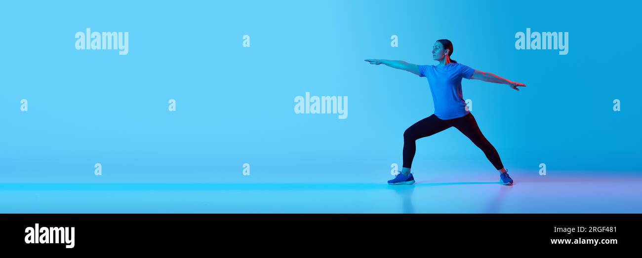 Dynamic postural. Mature woman in black bodysuit training, stretching ...
