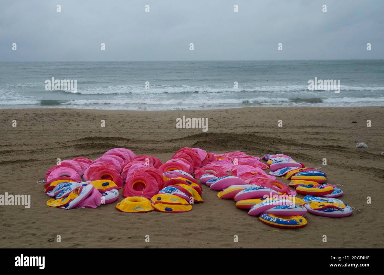 Deflated tubes are seen on a beach as the tropical storm named Khanun ...
