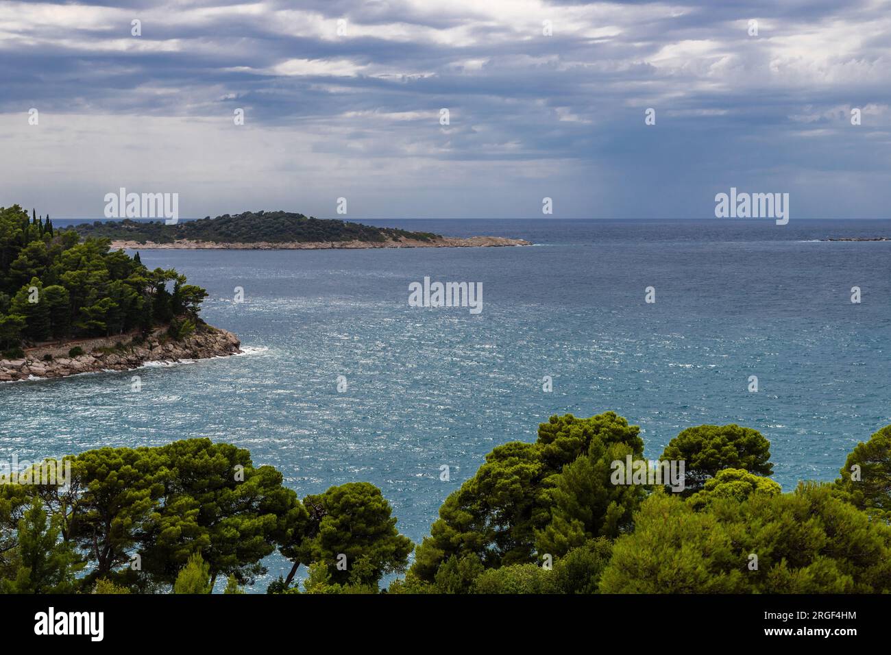 The rough coast line full with big rocks of the small fishing village ...