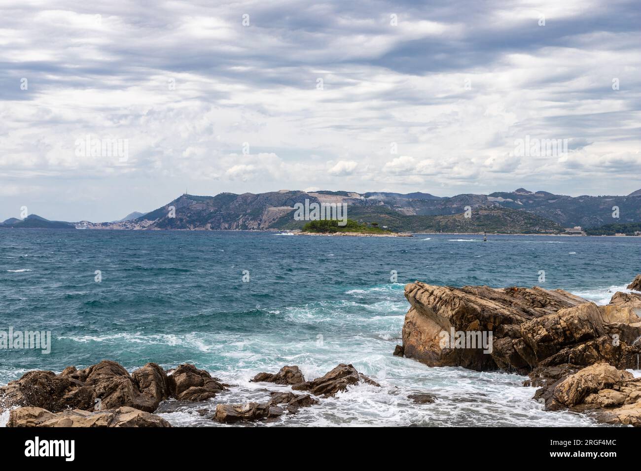 The rough coast line full with big rocks of the small fishing village ...