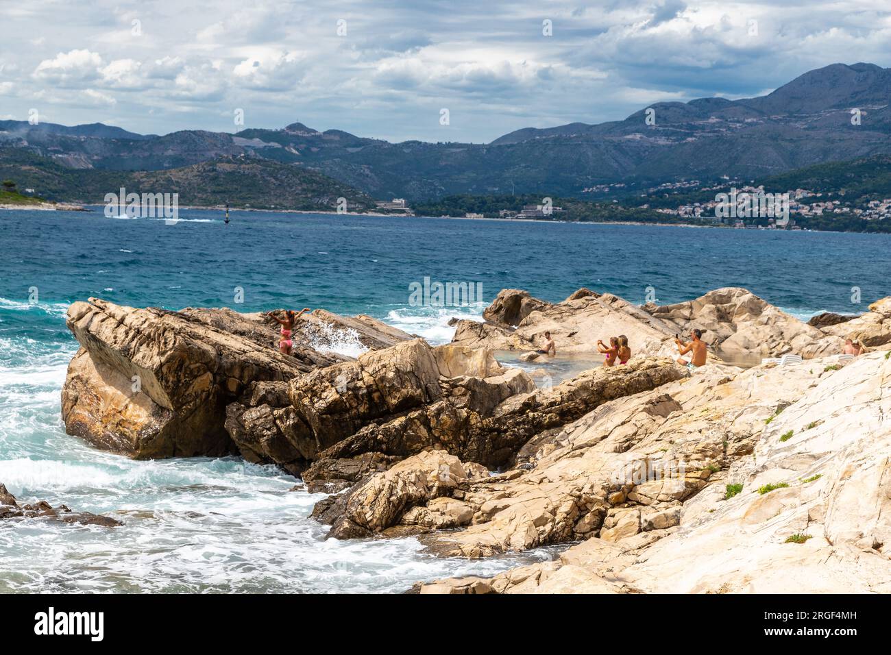 The rough coast line full with big rocks of the small fishing village ...