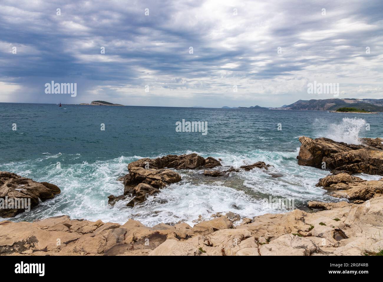 The rough coast line full with big rocks of the small fishing village ...