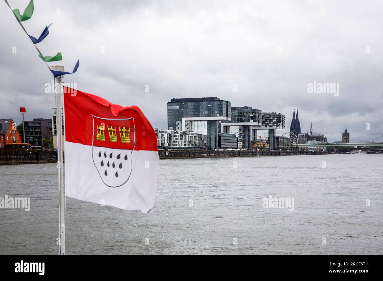 the Cologne flag on a ship in front of the Crane Houses in the Rheinau ...