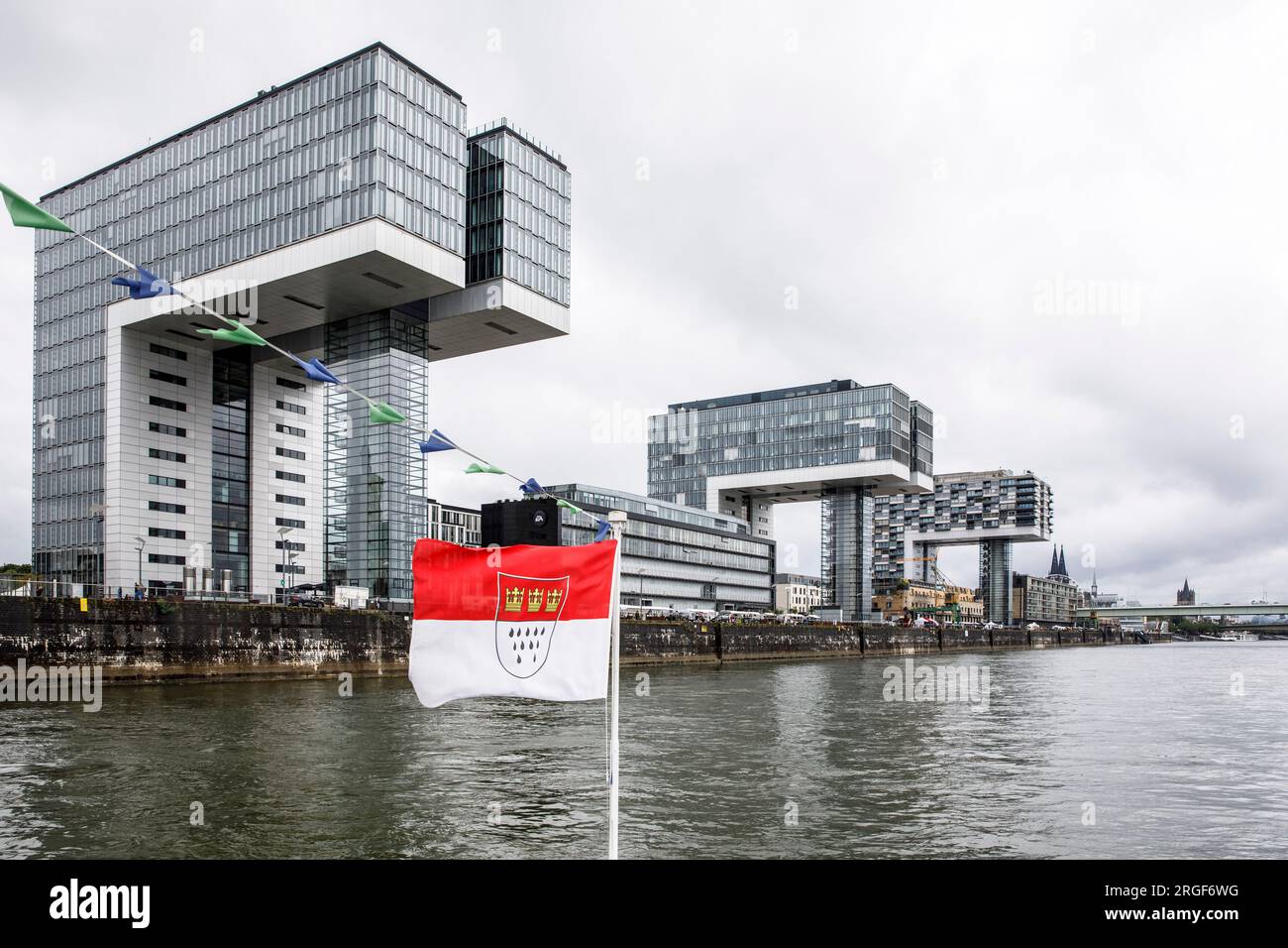the Cologne flag on a ship in front of the Crane Houses in the Rheinau ...