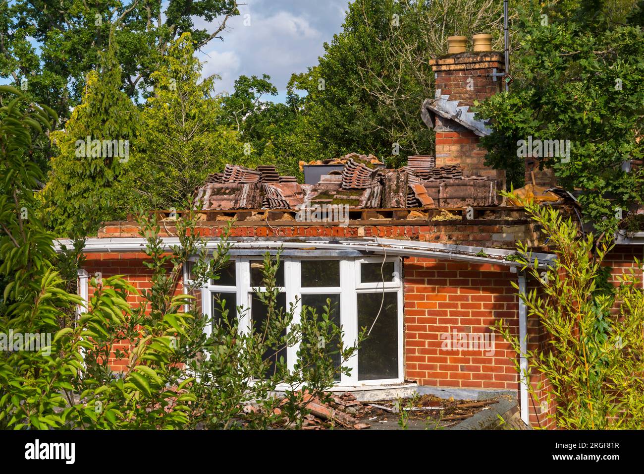 Start of house demolition removing tiles from roof at house in ...