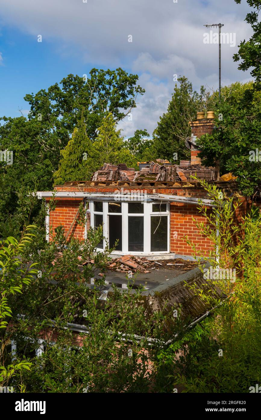 Start of house demolition removing tiles from roof at house in ...
