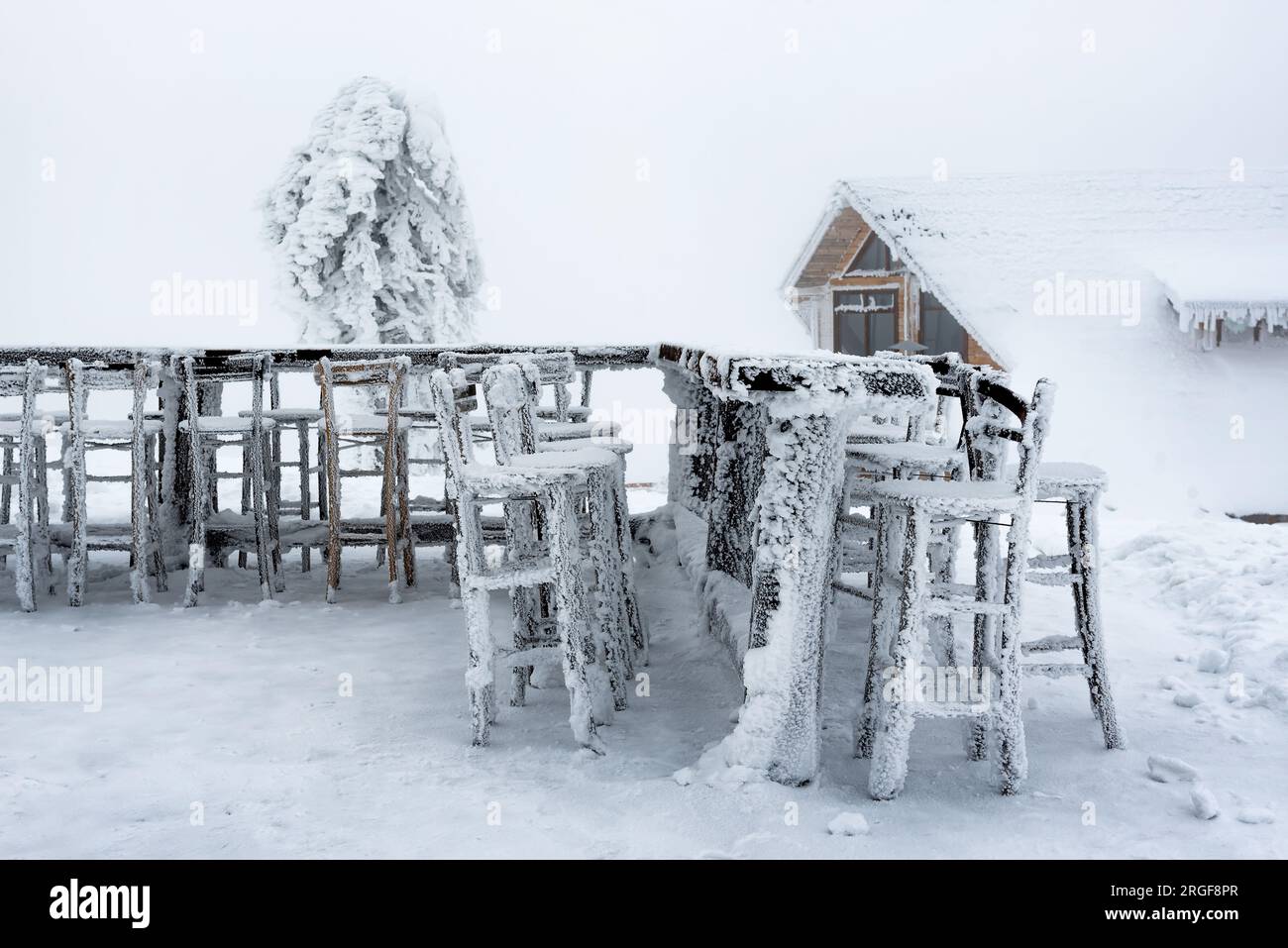 Winter scene in the mountains with snow covered and frozen cottage and ...
