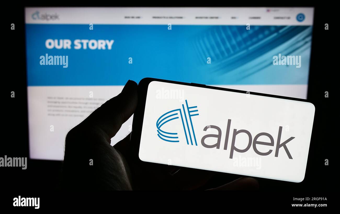 Person holding smartphone with logo of Mexican chemical company Alpek S ...