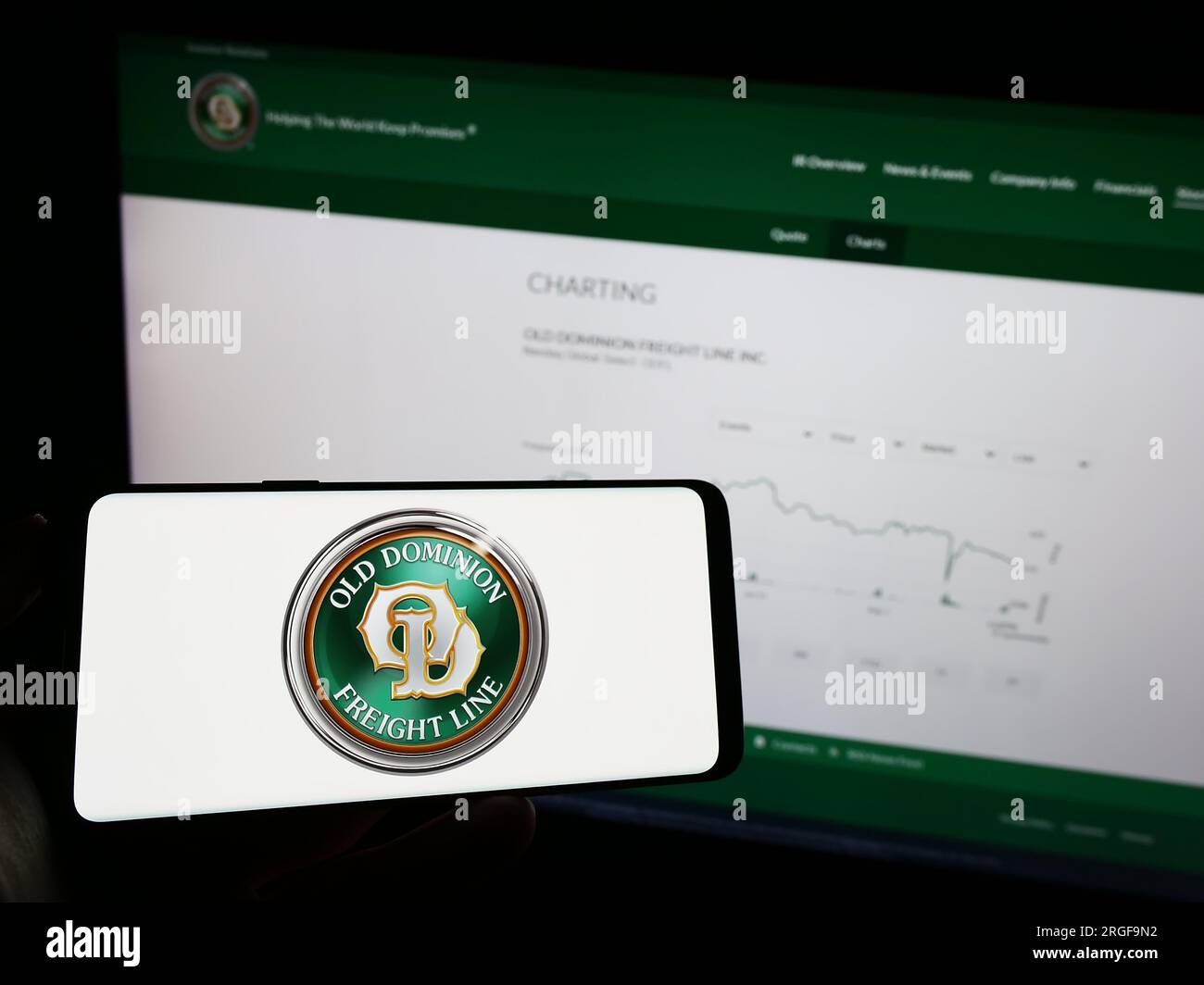 Person holding mobile phone with logo of company Old Dominion Freight ...