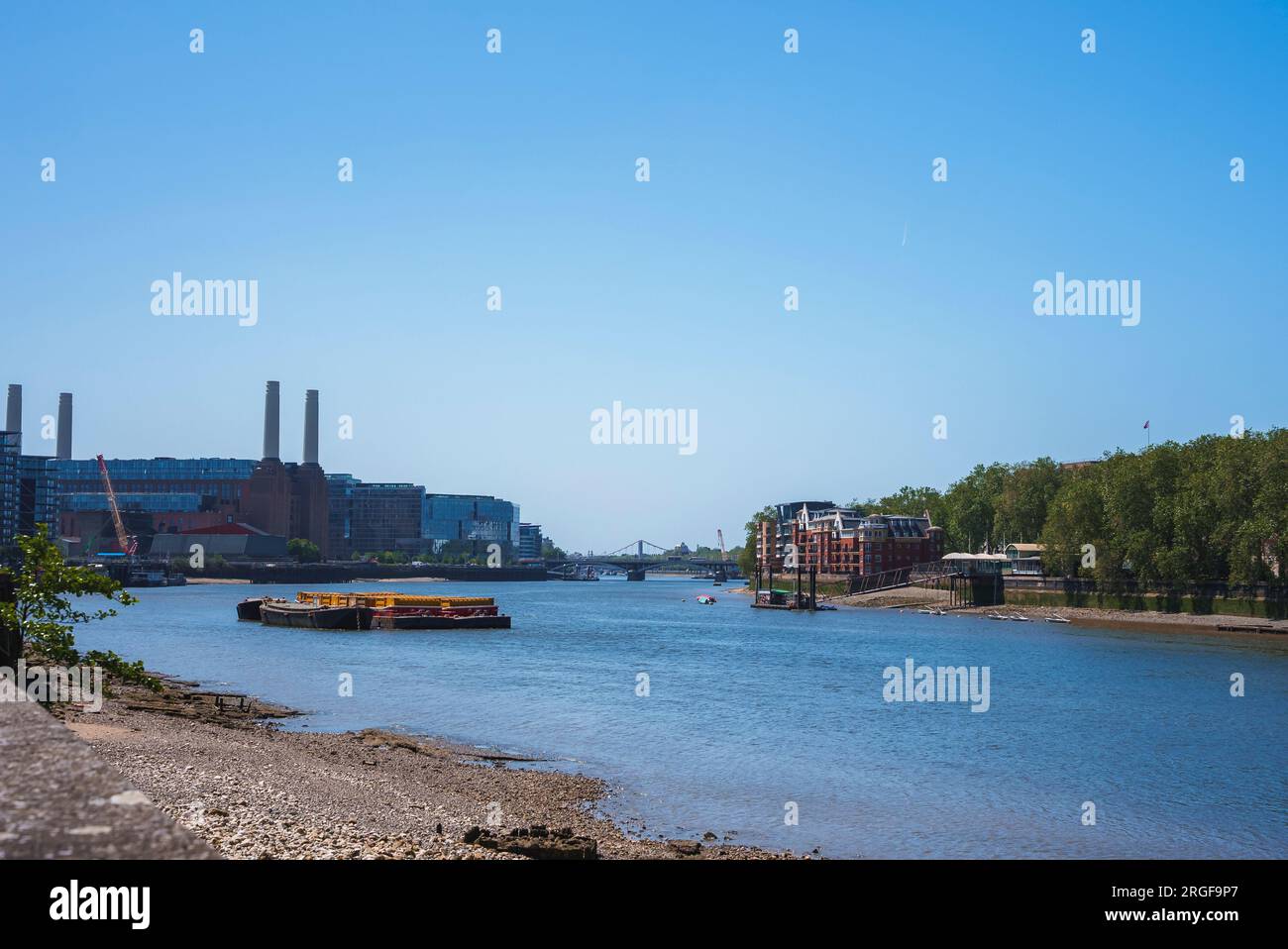 Battersea Power station at banks of Thames river with blue sky in ...