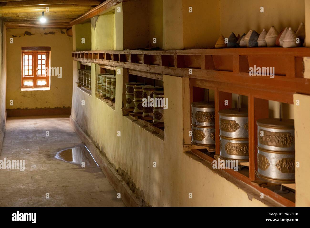 India, Ladakh, Zanskar, Sani, Monastery prayer wheels in cloister Stock ...