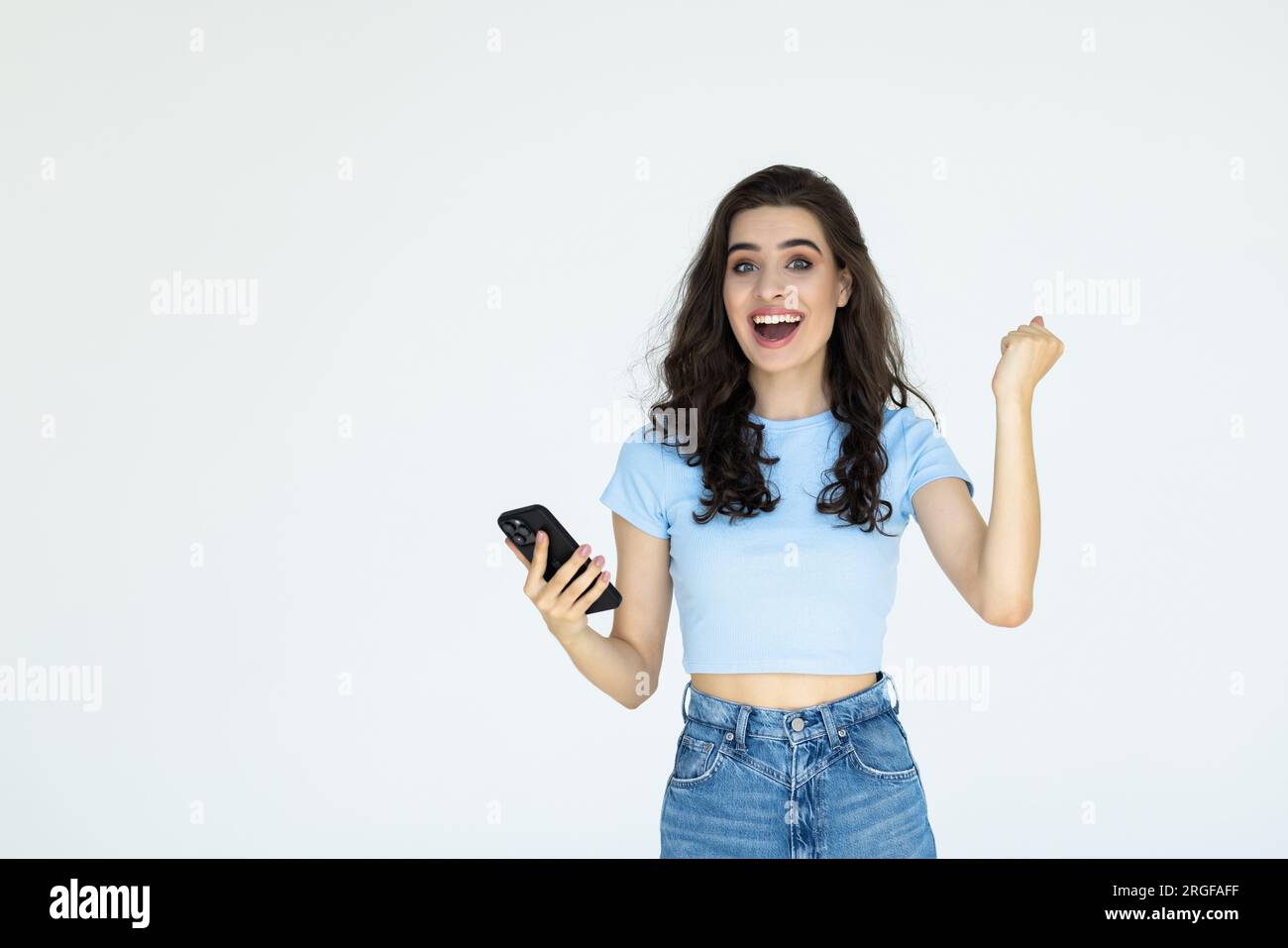 Beautiful young women play mobile game and put on wireless headphone ...