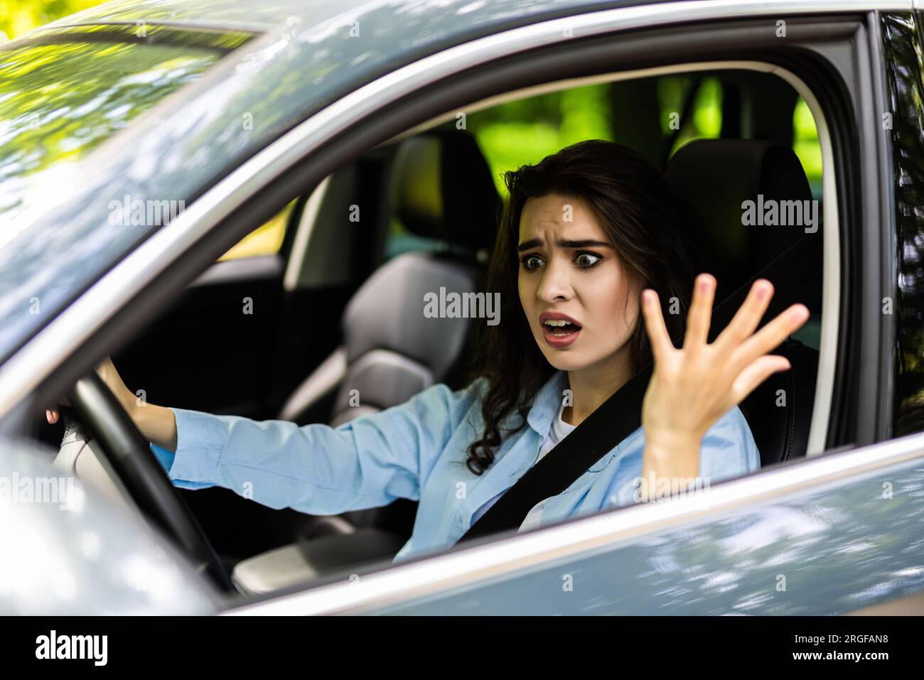 Stressed woman driver sitting inside her car. Angry female driver ...