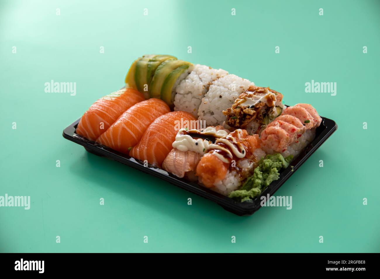 A take away sushi package isolated on cyan background Stock Photo - Alamy