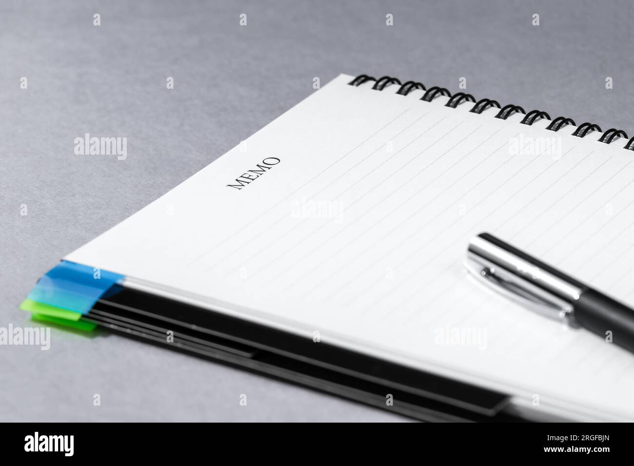 Opened spiral notebook with page markers and black pen, black metal ...