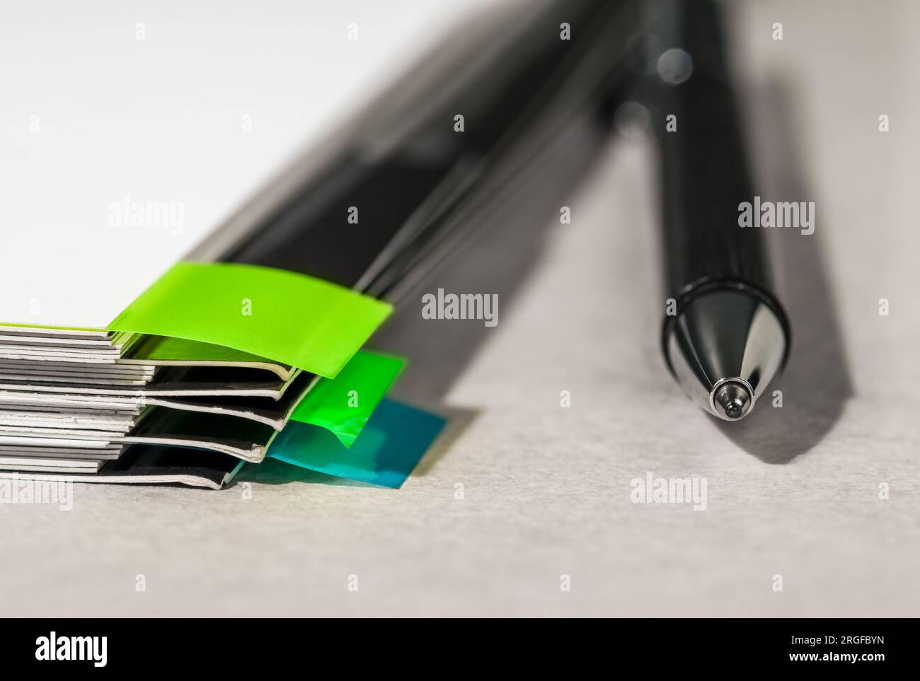 A pile of paper documents and a pen on the table in the office Stock ...