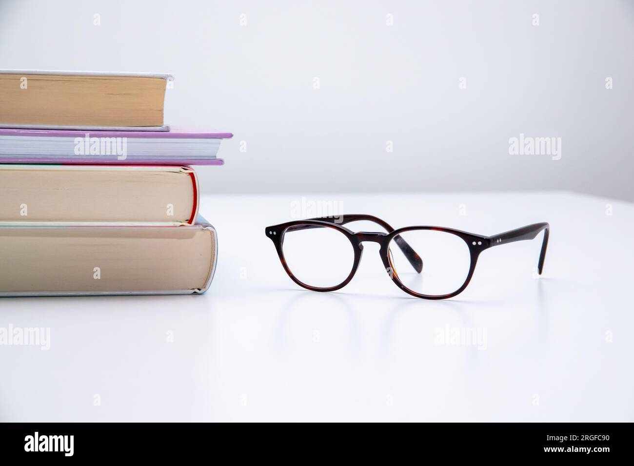 A Stack of books with glasses next to them Stock Photo - Alamy