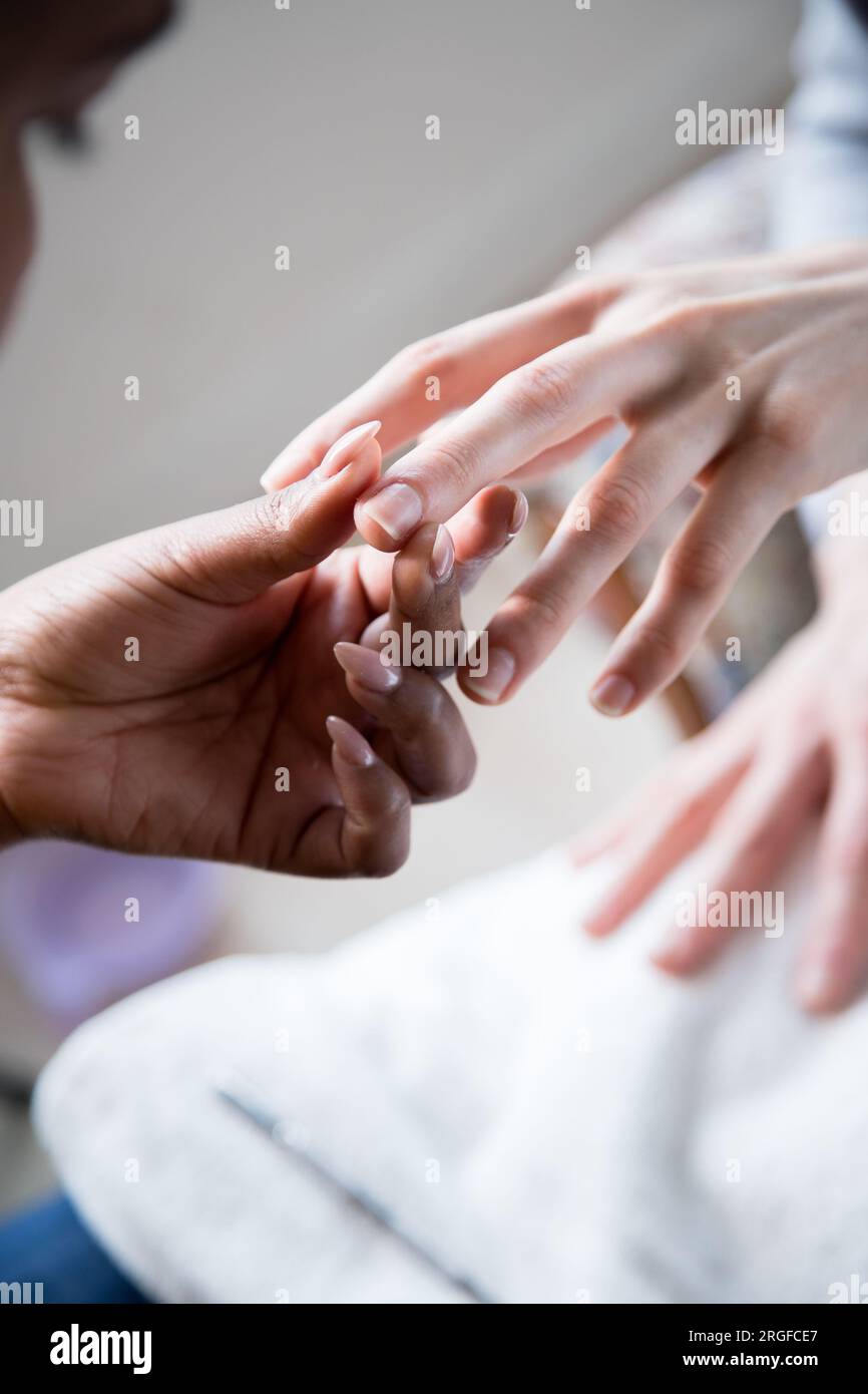 Woman taking care of her nails with a manicure service. Hands of a ...