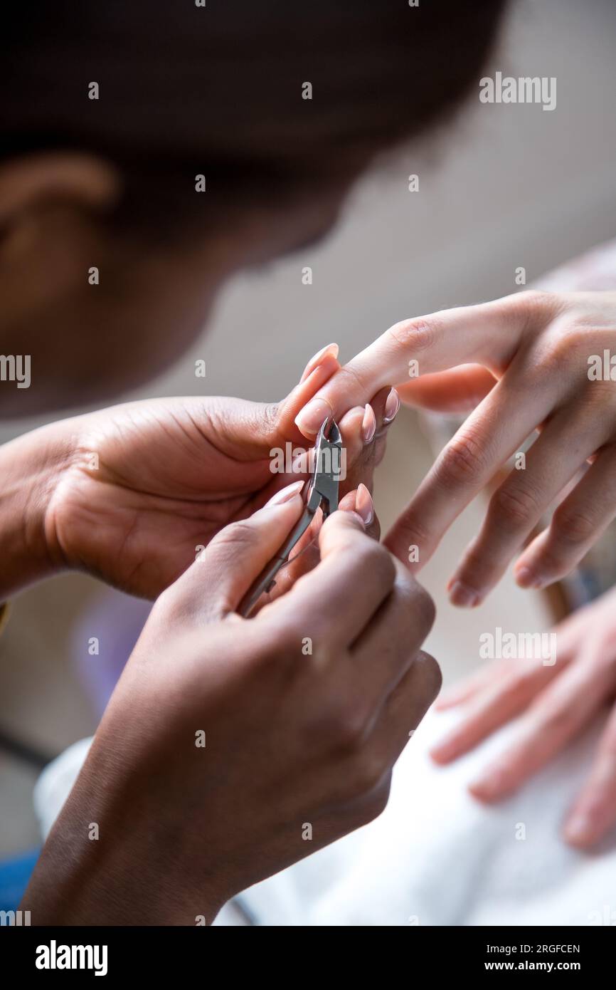 Woman taking care of her nails with a manicure service. Hands of a ...