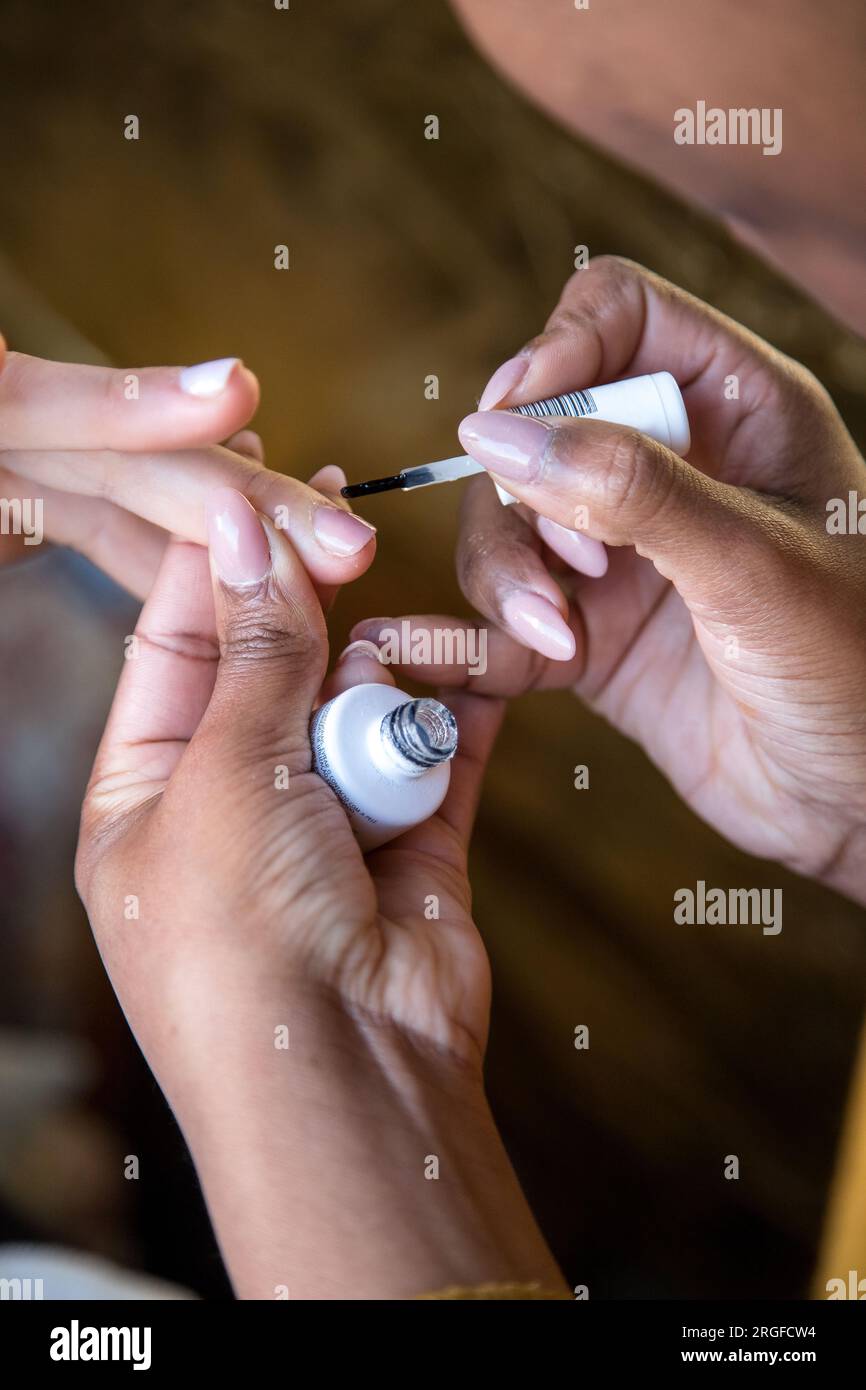 Woman taking care of her nails with a manicure service. Hands of a ...