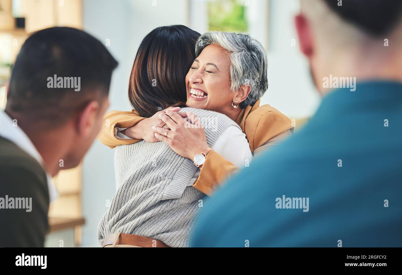 Business people, women and hug in group therapy in office, care or ...