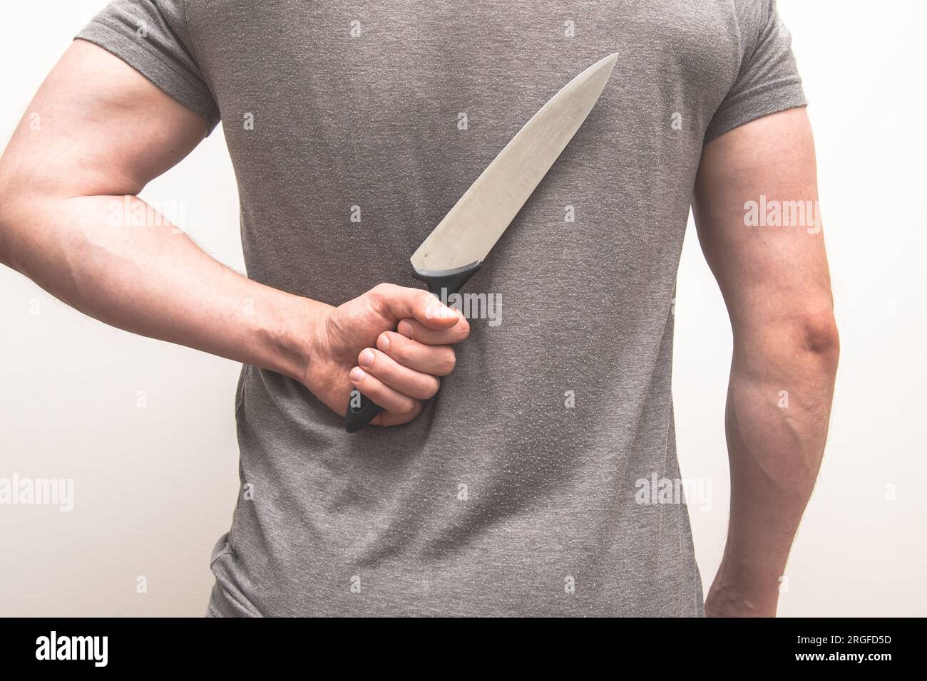 AMan holding a kitchen knife behind his back Stock Photo - Alamy