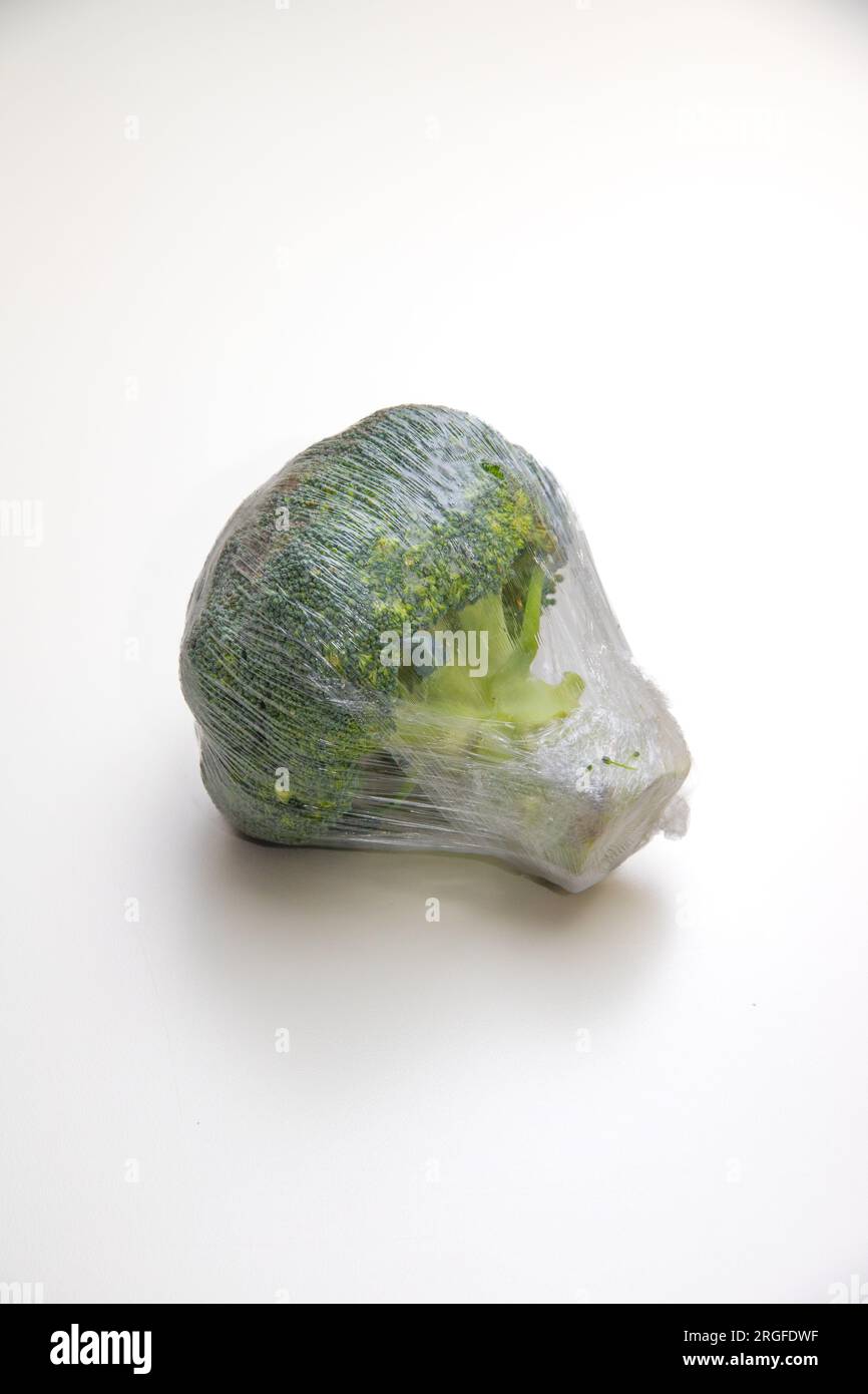 An Isolated broccoli wrapped into plastic Stock Photo - Alamy