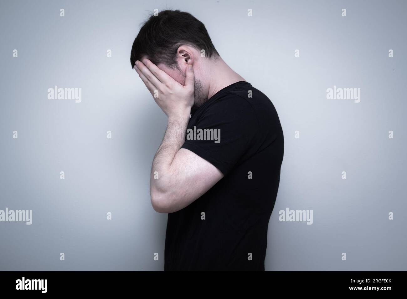 A man covering his face with his arm Stock Photo - Alamy