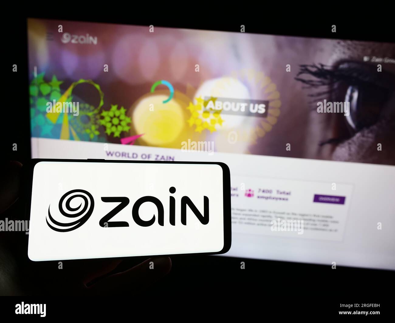 Person holding smartphone with logo of Mobile Telecommunications ...