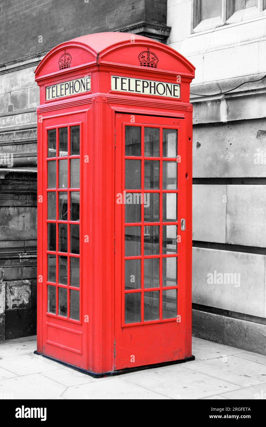Color isolated red phone booth in London on black and white surrounding ...