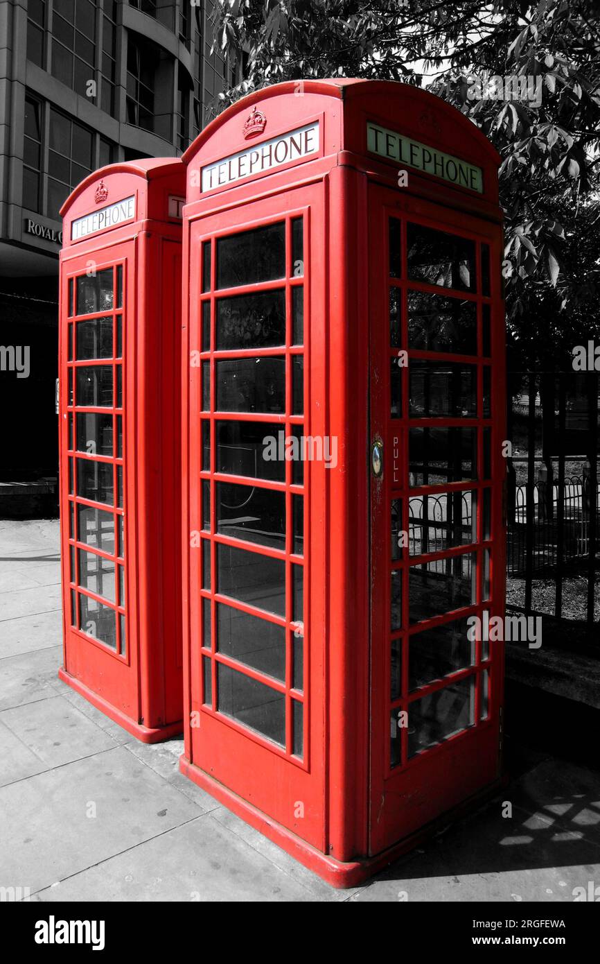 Color isolated red phone booths in London on black and white ...