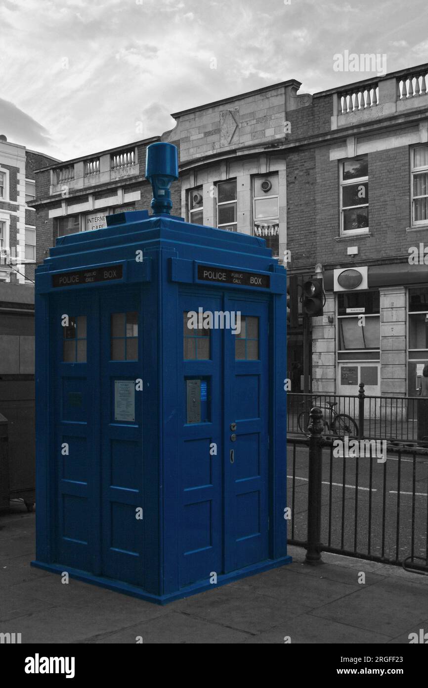Color isolated blue police public call box in London on black and white ...