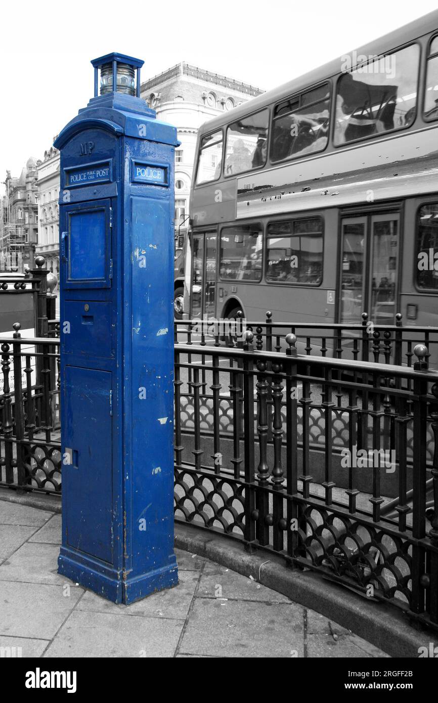 Color isolated blue police public call post in London on black and ...
