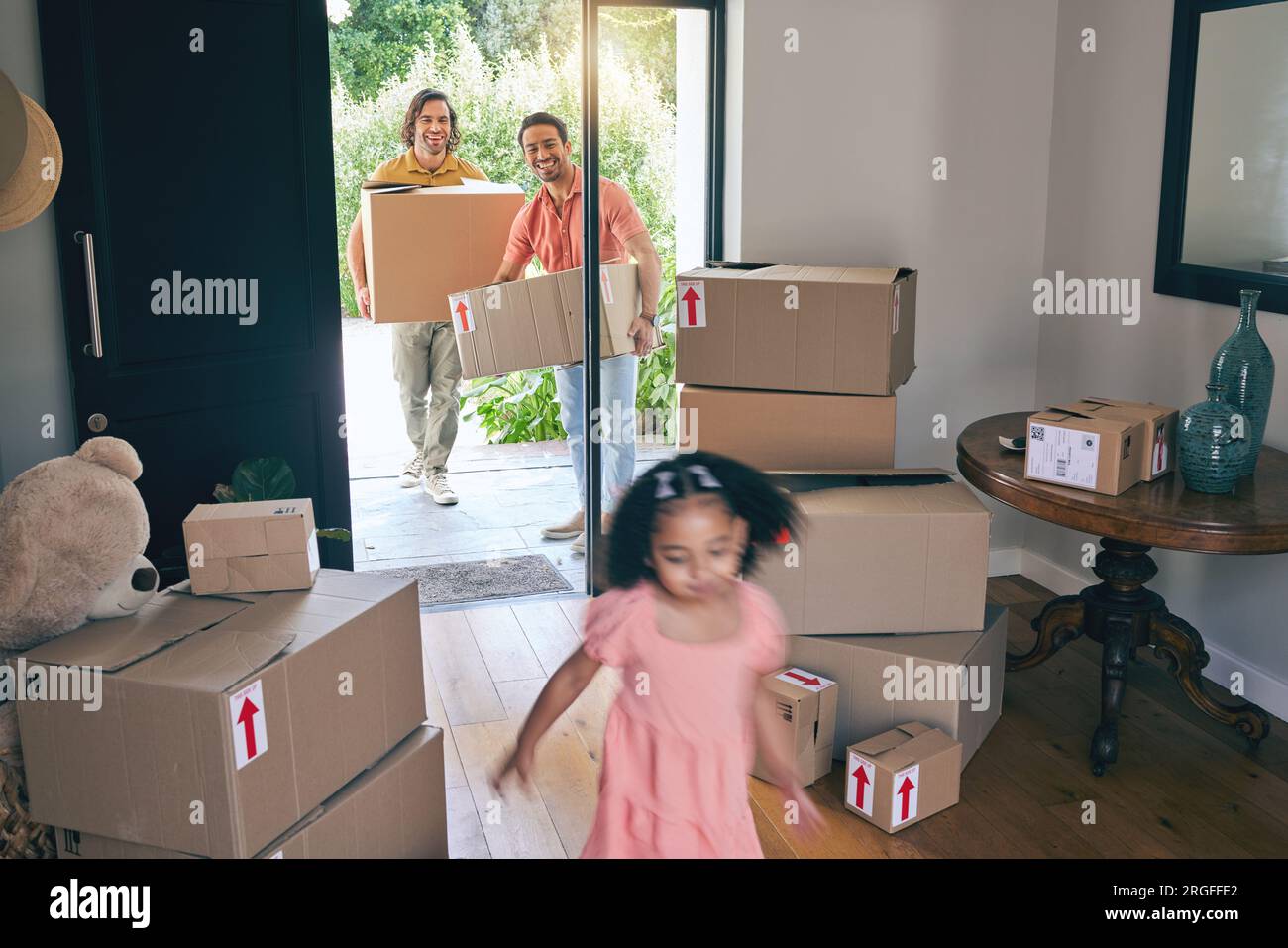 Gay father, moving and girl child running in new home with motion blur ...