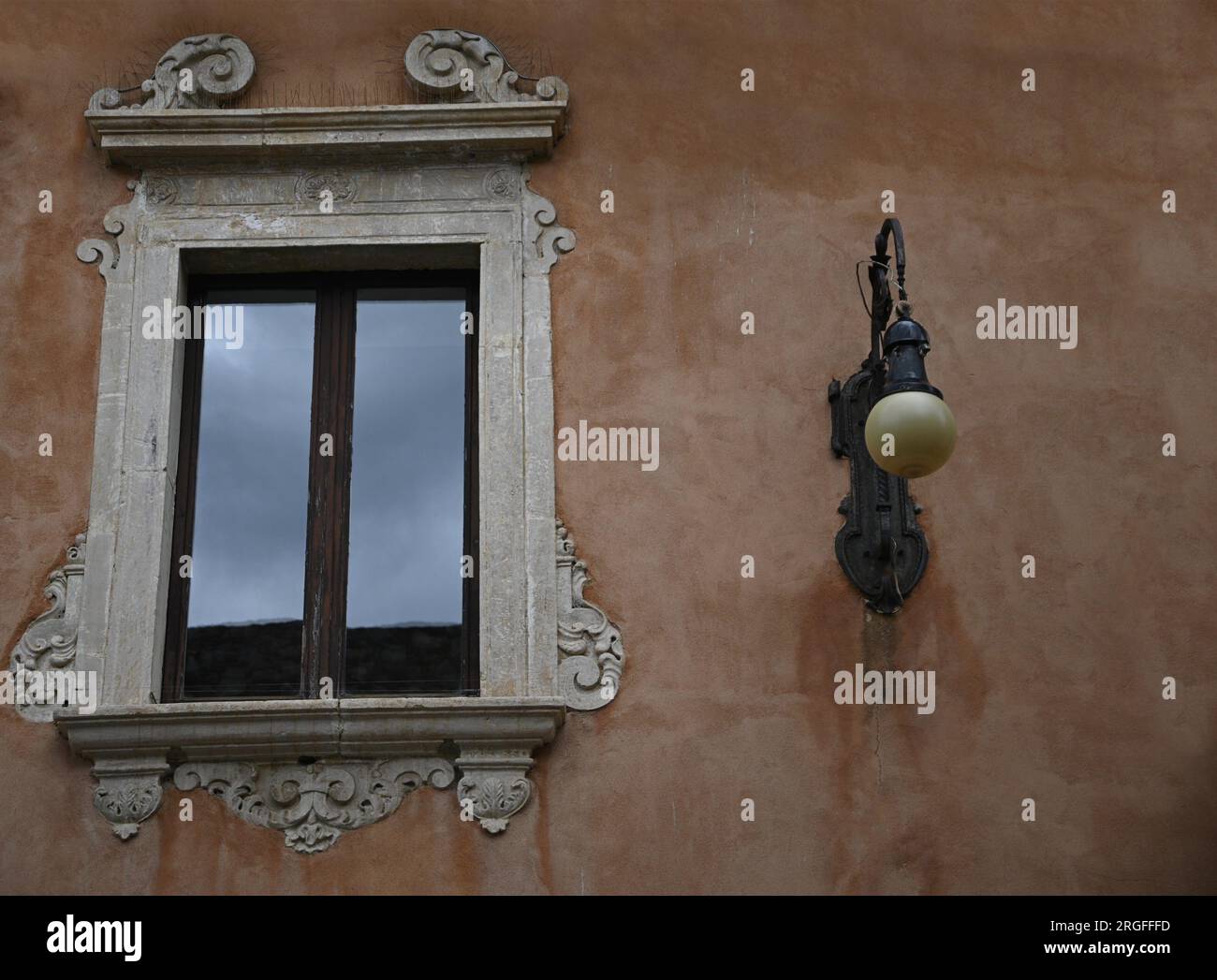 Antique Neoclassical house window with a marble sculpted trim on a ...