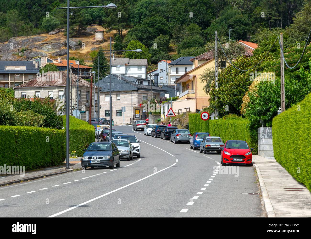 Main road cars parked village housing, Avion, Ourense, Galicia, Spain ...